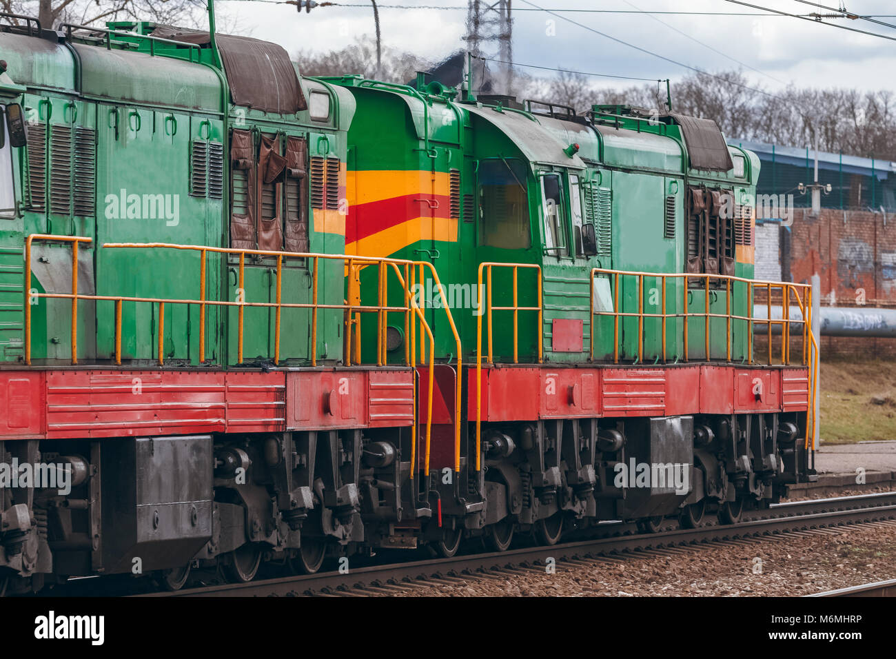 Green diesel cargo locomotive. Freight train in action Stock Photo - Alamy