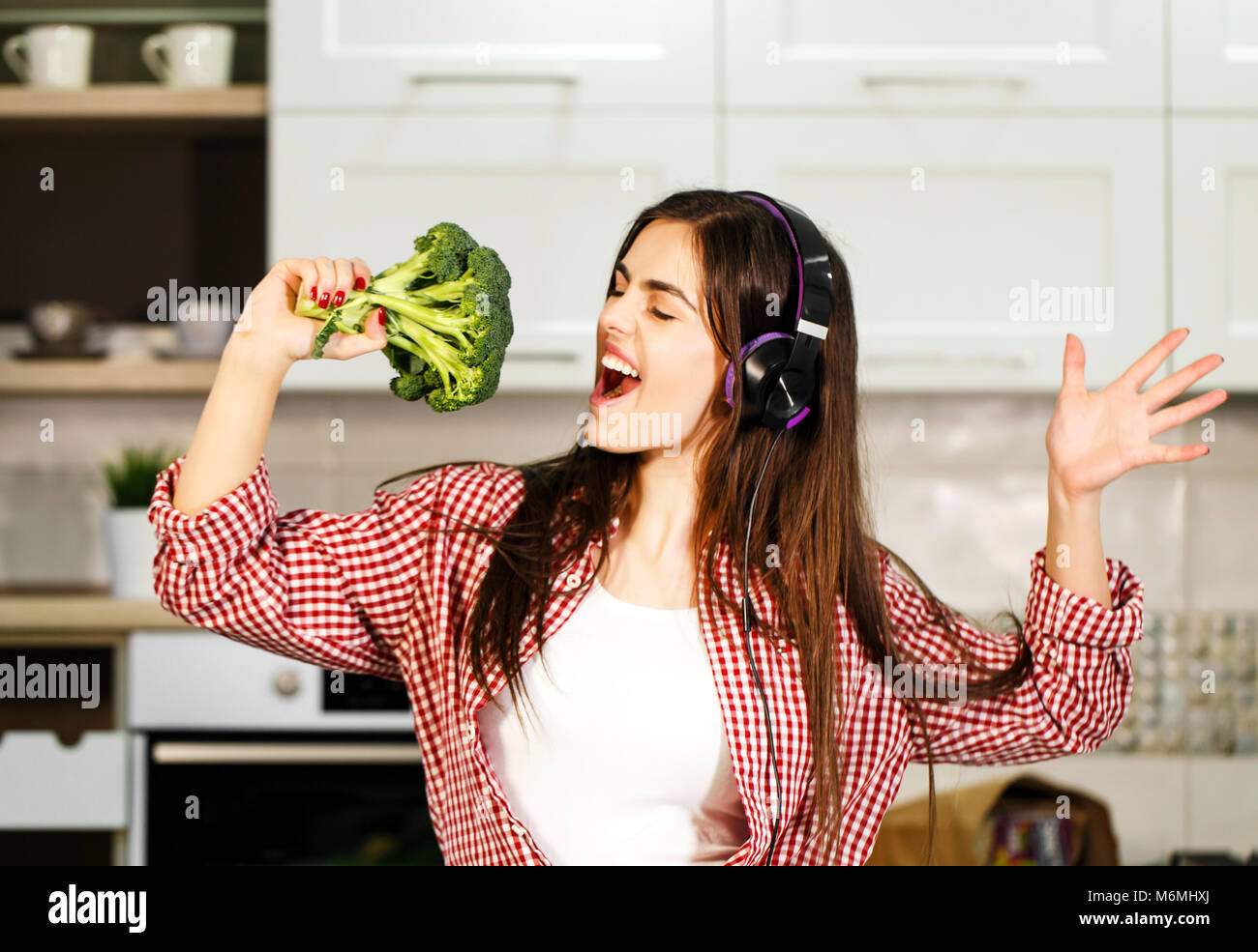 Girl Singing as Cooking Stock Photo - Alamy