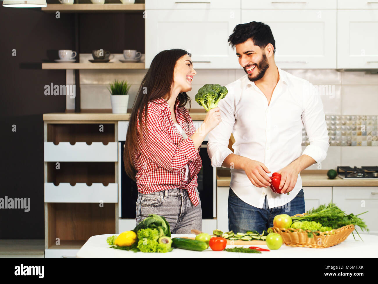 Couple Having Fun During Meal Prep Stock Photo - Alamy
