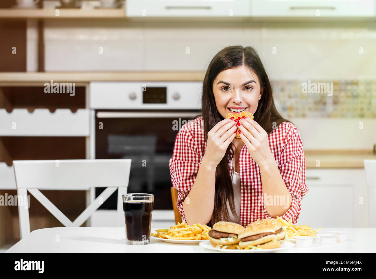 Student girl eating hamburger hi-res stock photography and images - Alamy