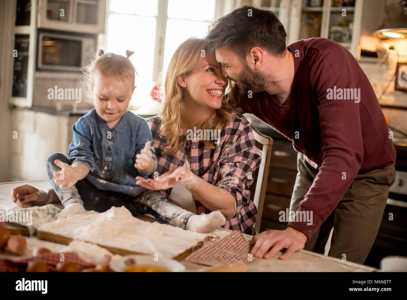 Happy family making pasta in the kitchen at home Stock Photo - Alamy