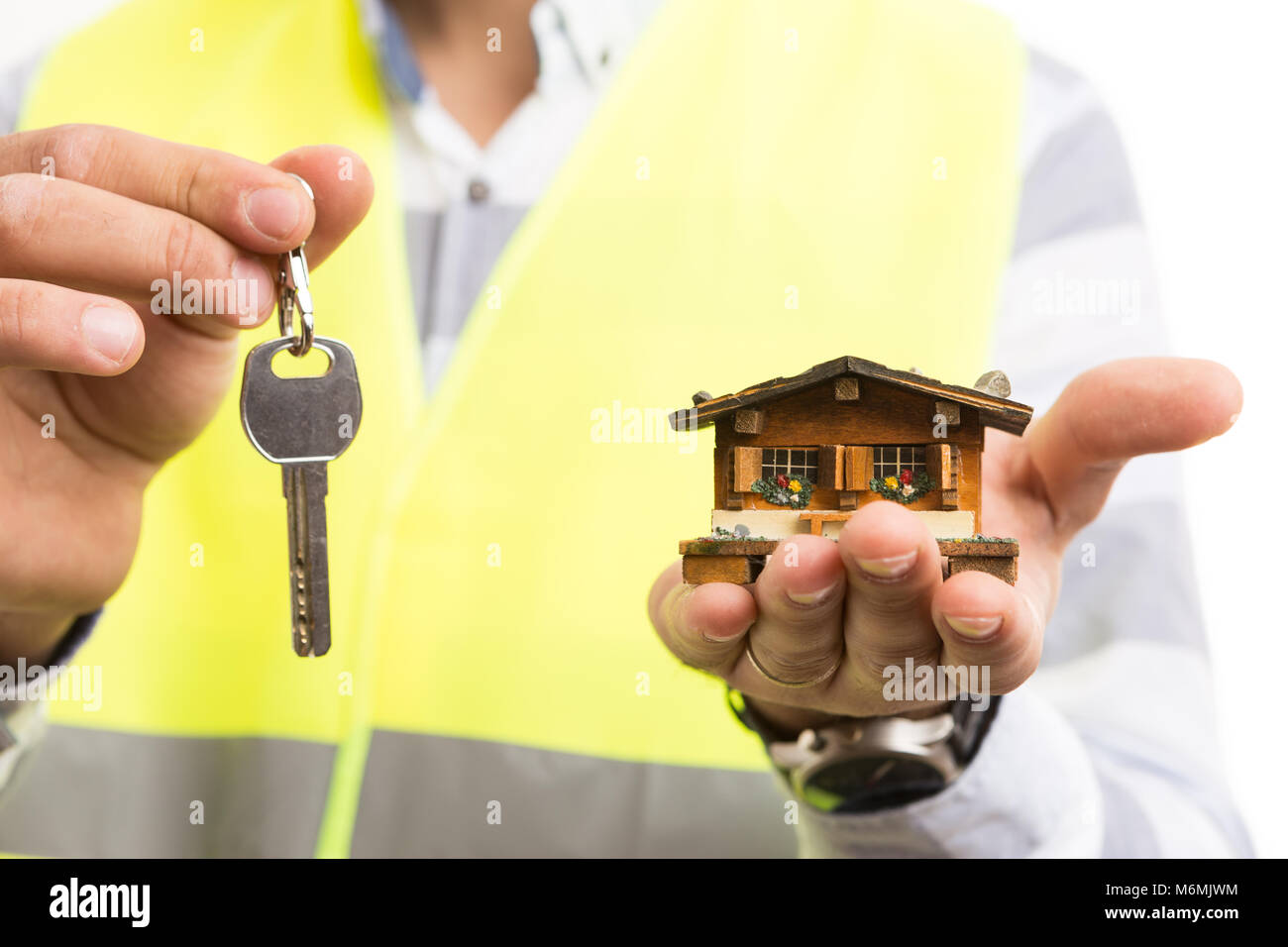 Architect or builder hands holding keys and house model as real estate ...