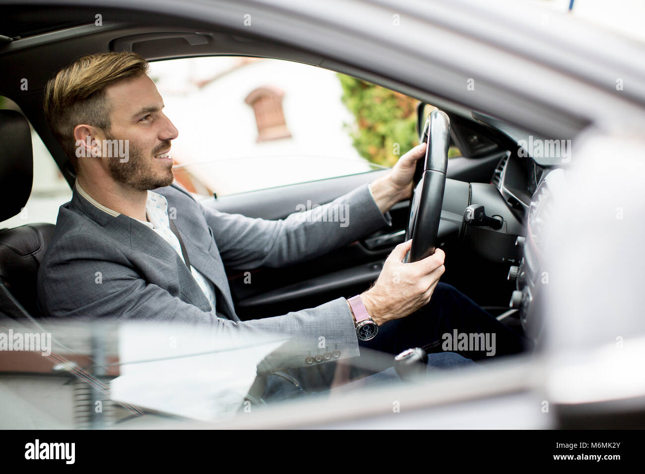 Young businessman driving in the modern car Stock Photo - Alamy