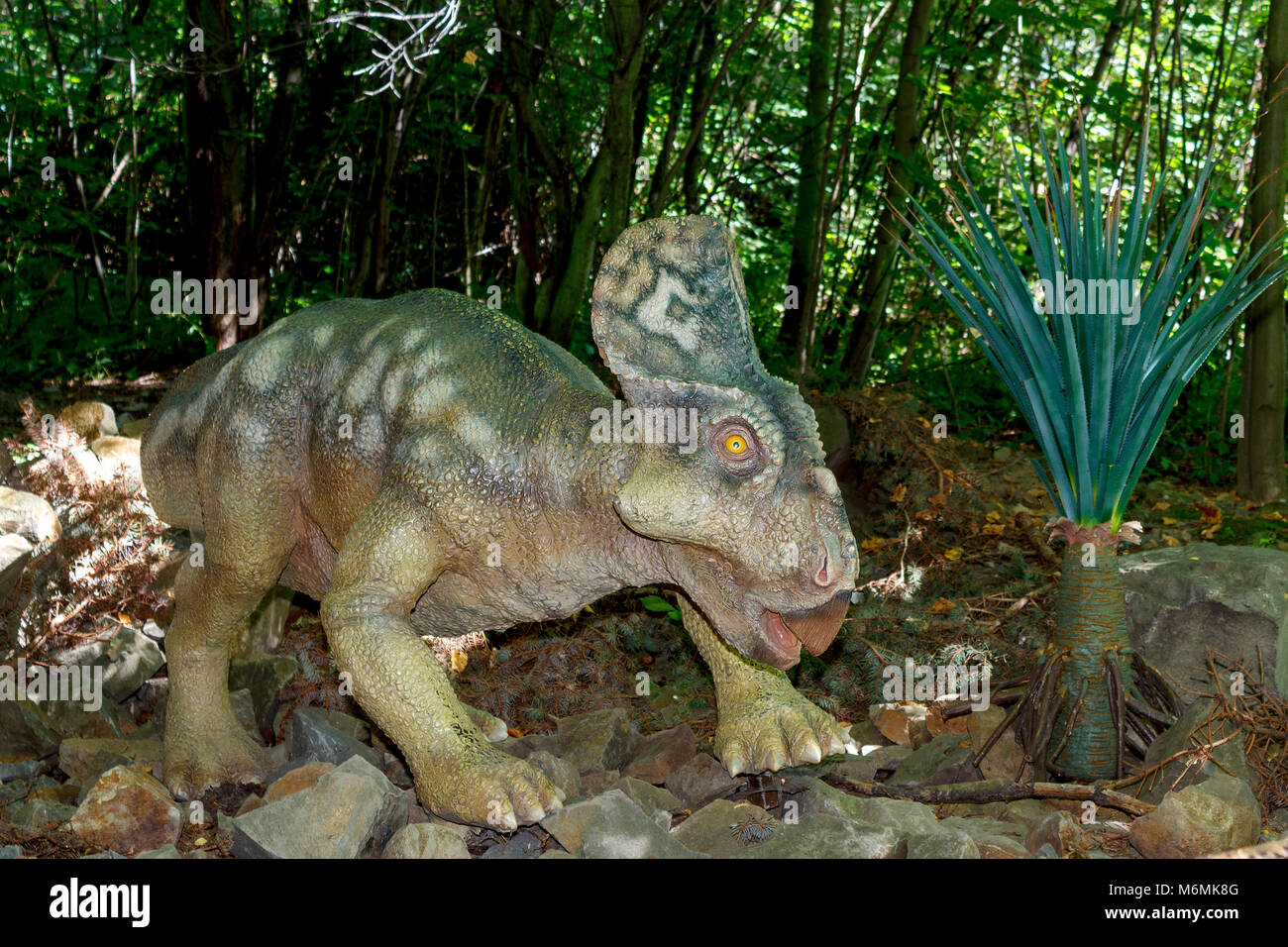 Big model of small baby of prehistoric dinosaur in nature. Realistic ...