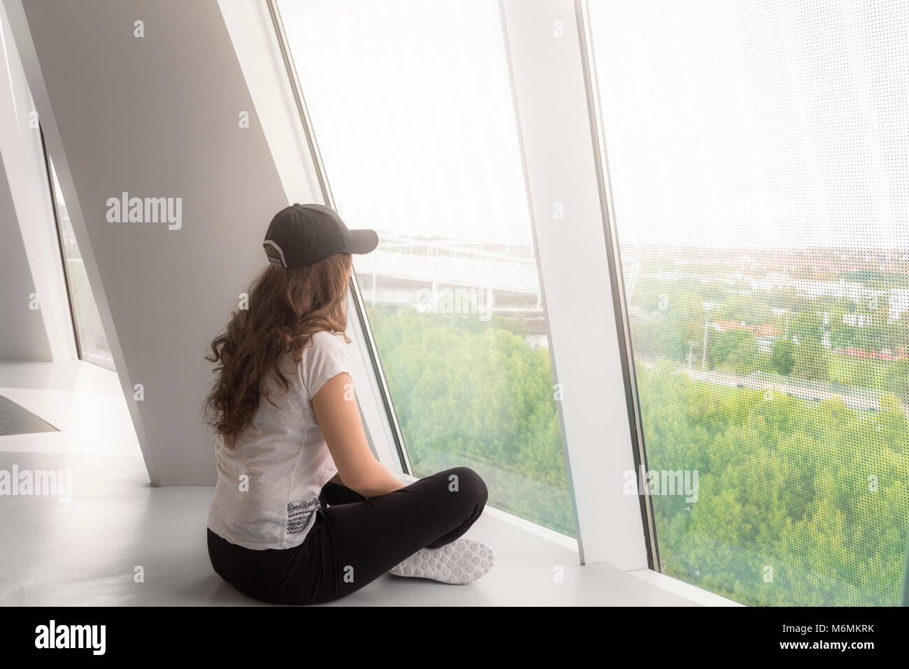 Sitting on windows hi-res stock photography and images - Alamy