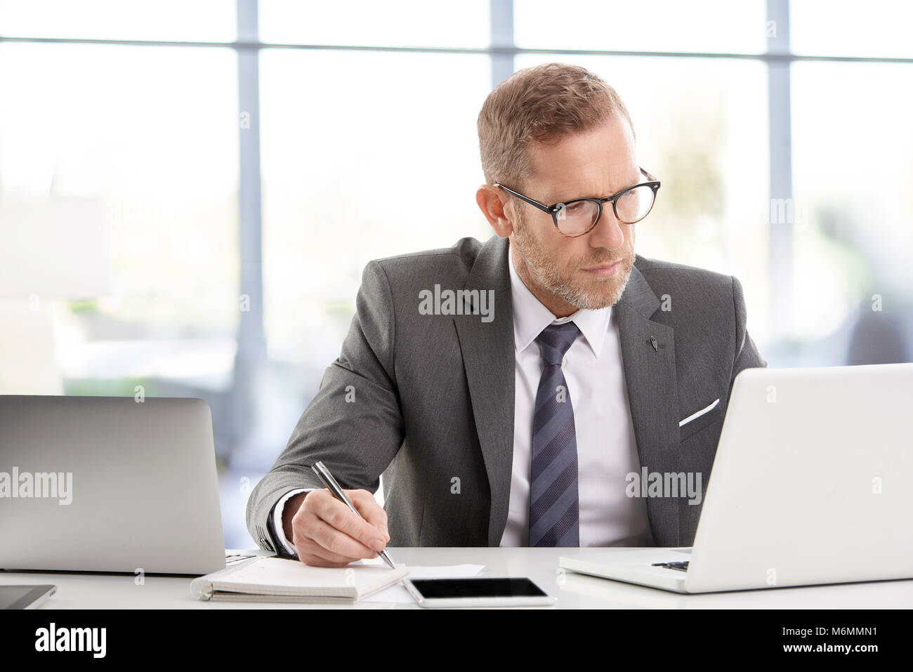 Executive senior financial director businessman doing some paperwork ...