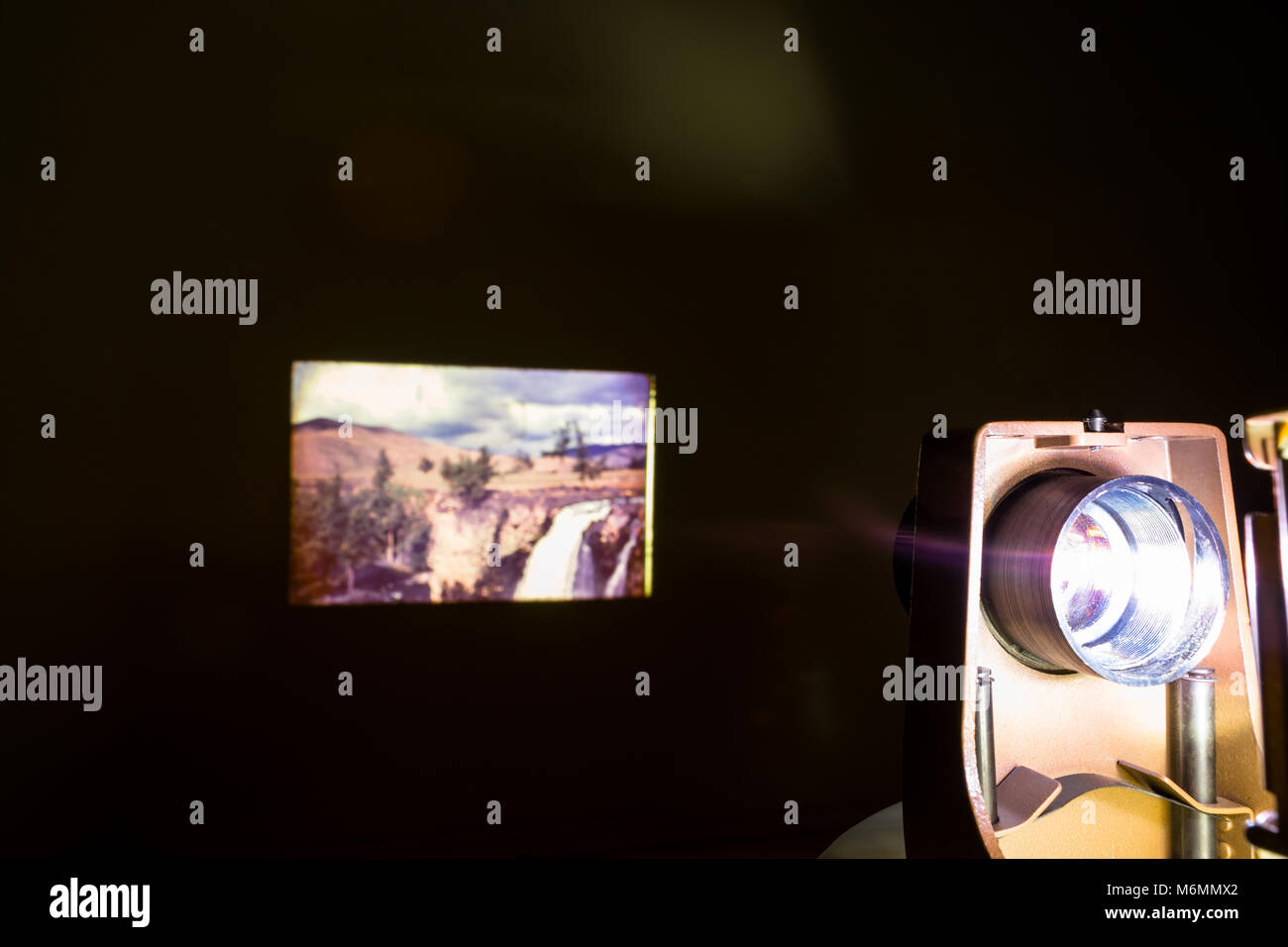 Vintage photo slides projector showing old photographs slides in dark ...