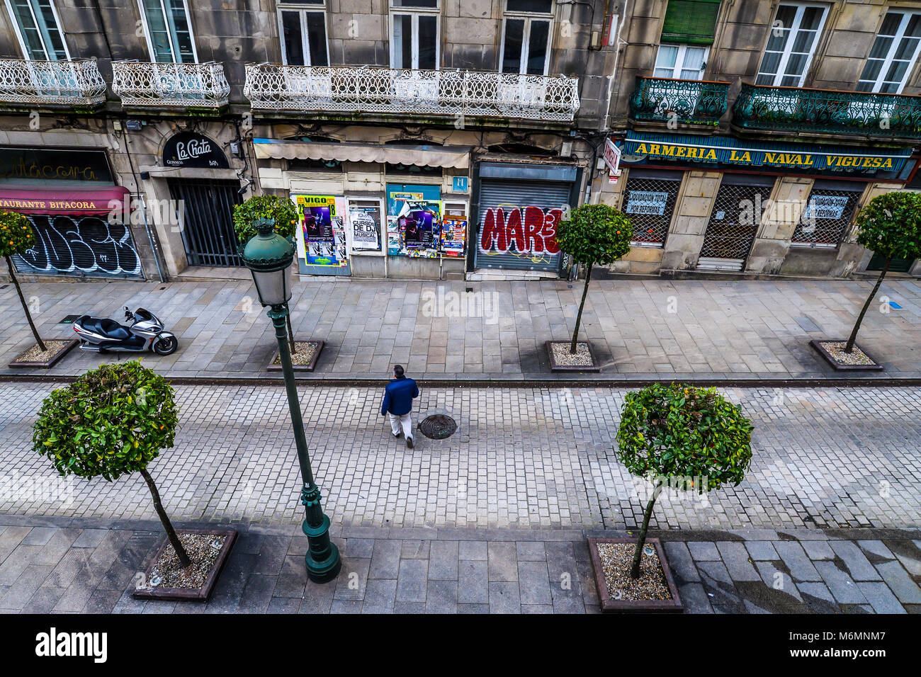 A man crossing the street in Vigo Stock Photo - Alamy