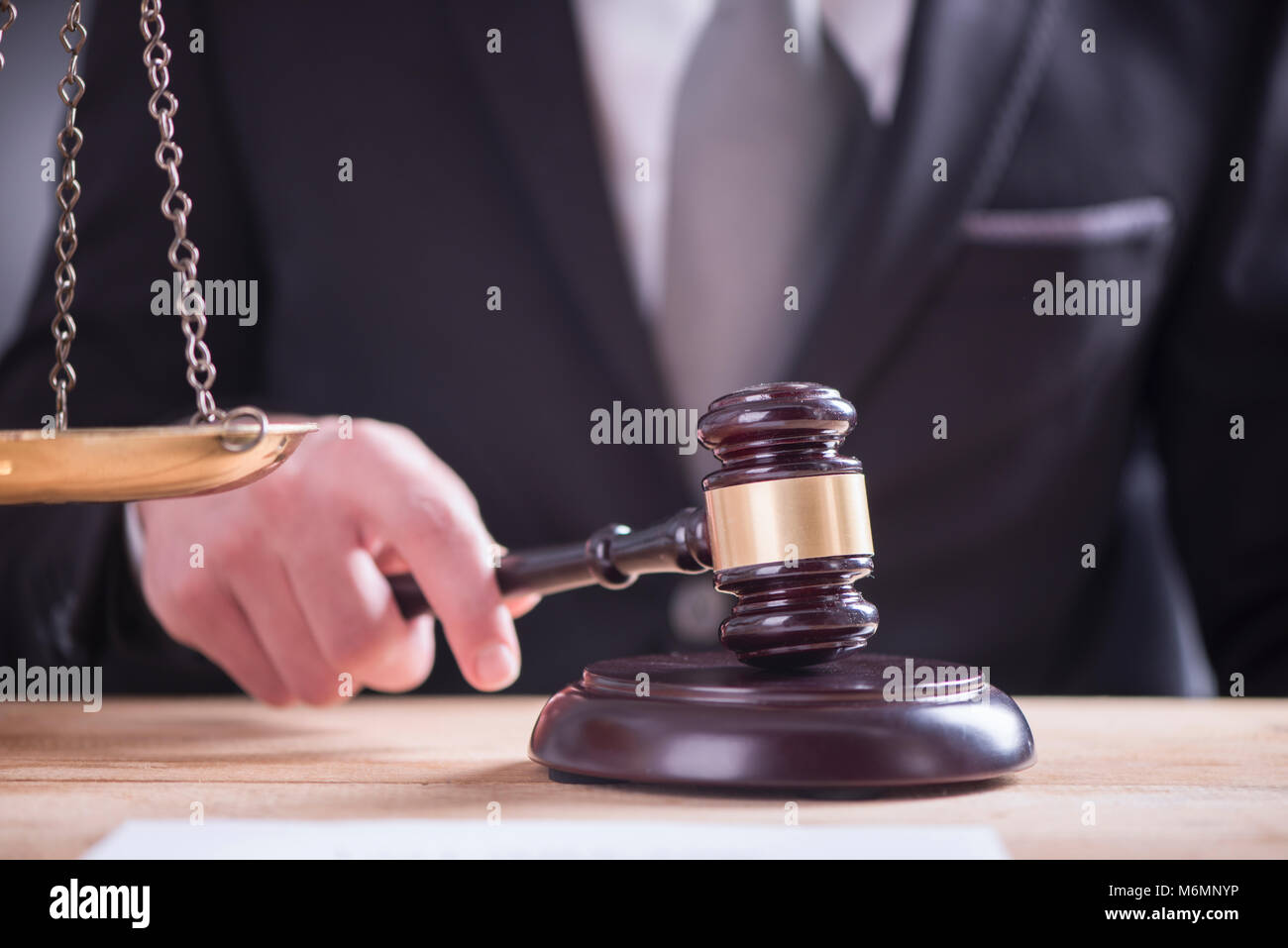 Close up of Male lawyer or judge hand's striking the gavel on sounding ...