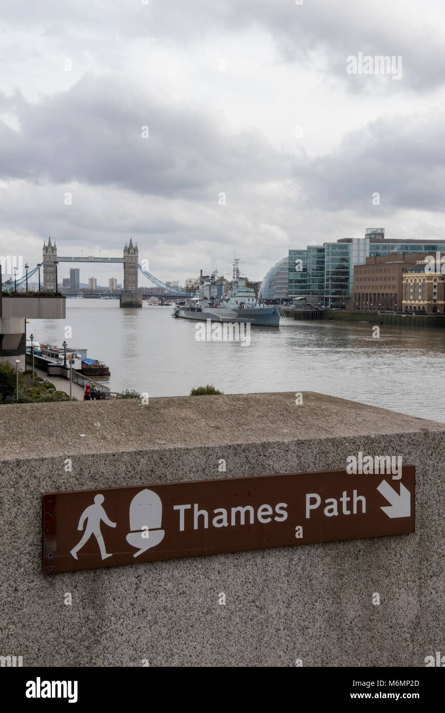 a tourist information sign for the Thames path on the side of the river ...
