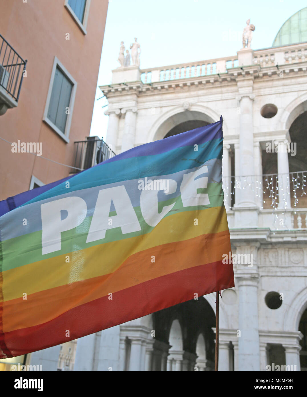 historic Italian monument and the multicolored flag with the word PACE ...