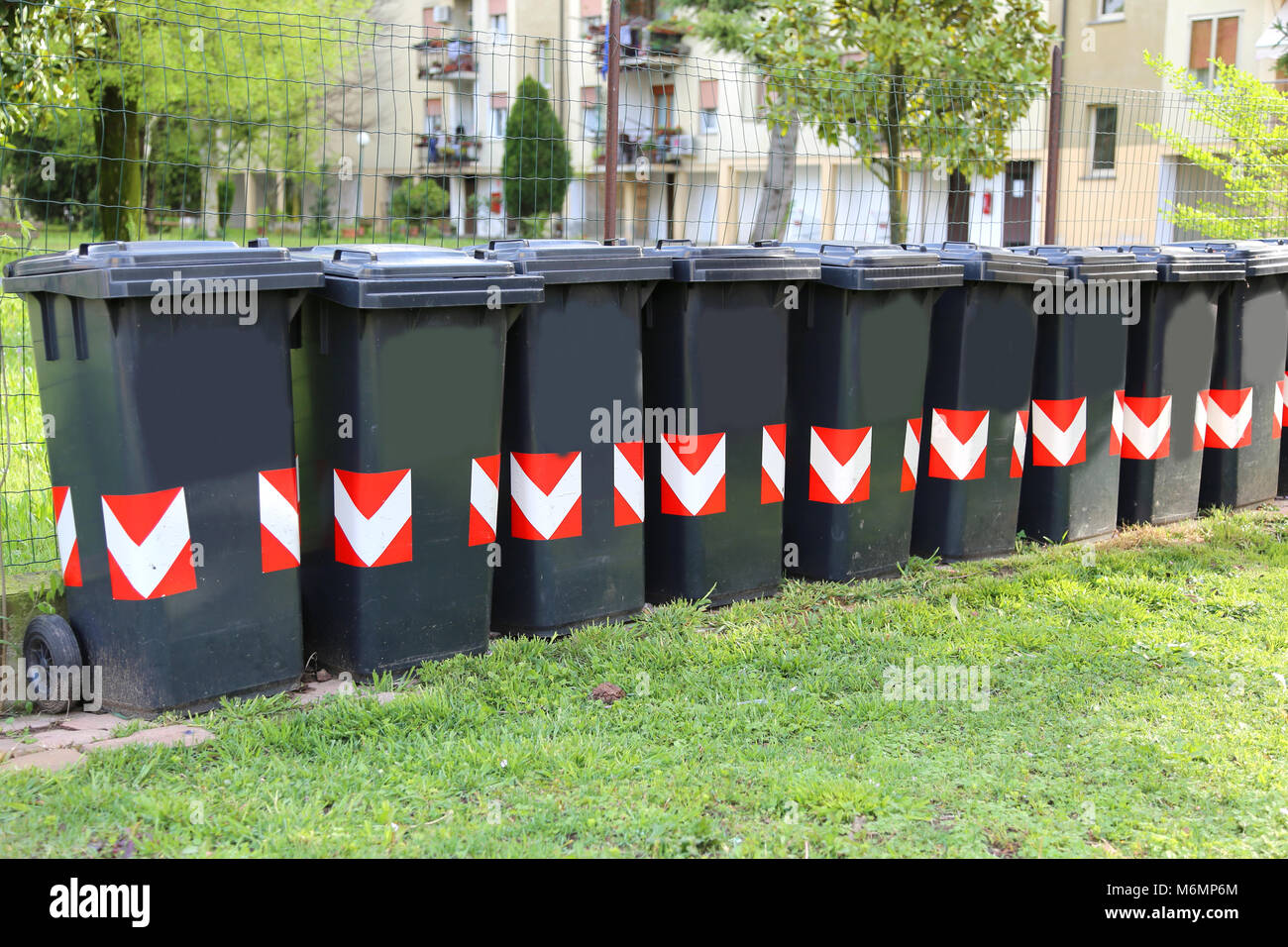 series of garbage cans in a condominium yard for the separate ...