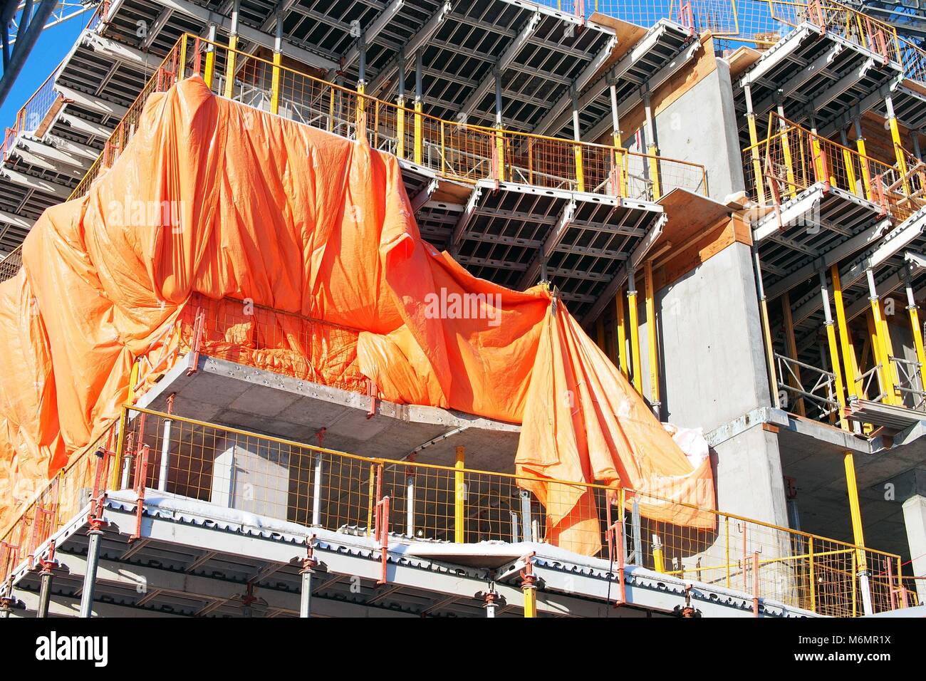 Orange tarpaulin draped over a corner floor on a condominium ...