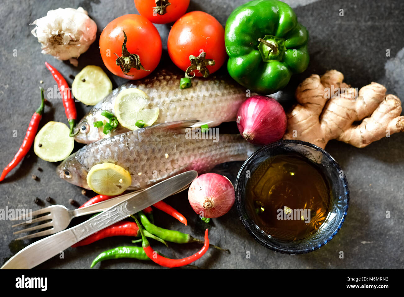 Raw freshest fish with cooking mineral on rough stone background. Raw ...