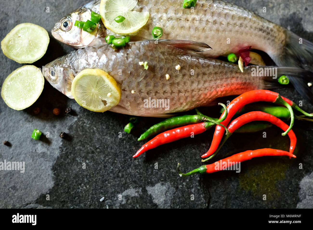 Raw freshest fish with cooking mineral on rough stone background. Raw ...