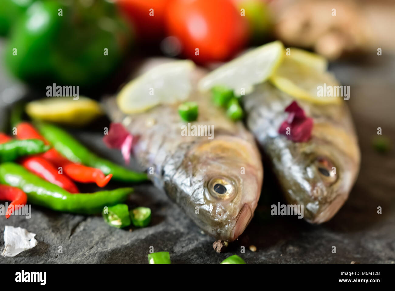 Raw fish on table for cooking Stock Photo - Alamy
