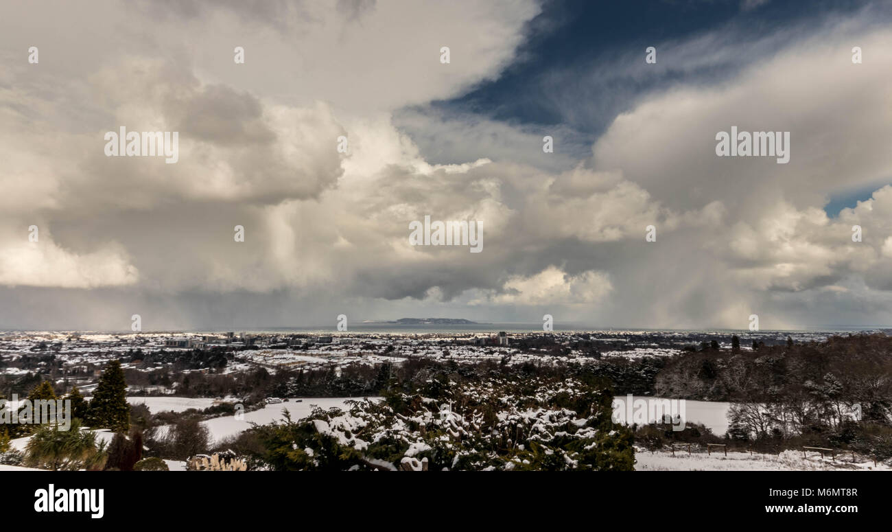A scenic view of Dublin bay from the Dublin mountains on a snowy day ...