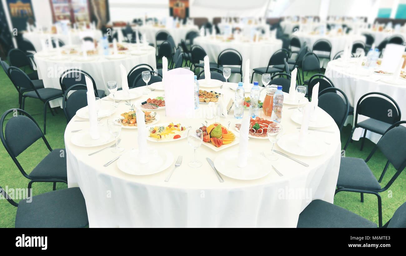 catering table set service with silverware Stock Photo - Alamy