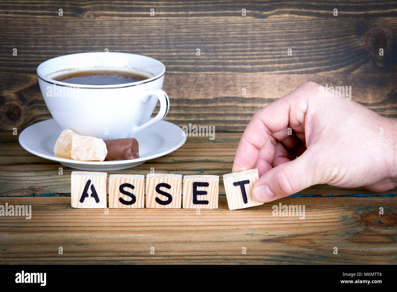 asset. Wooden letters on the office desk, informative and communication ...