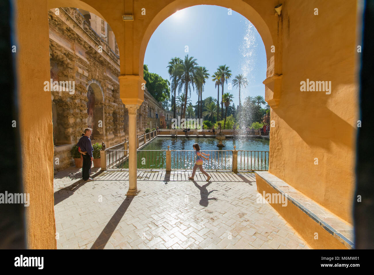 a young girl prancing around a court yard in Seville, Spain Stock Photo ...