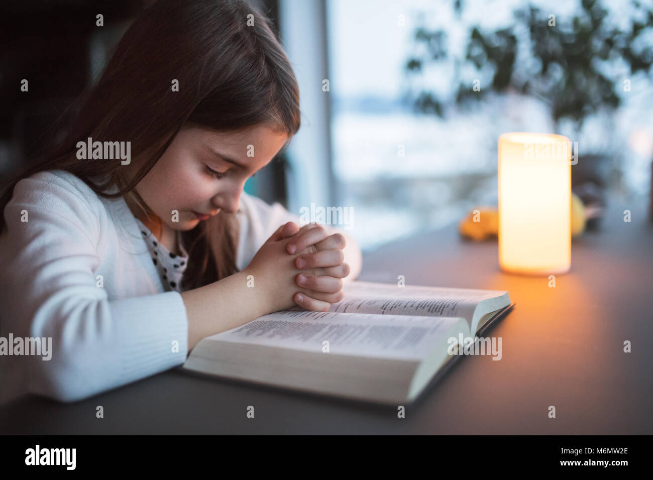 A small girl praying at home Stock Photo - Alamy