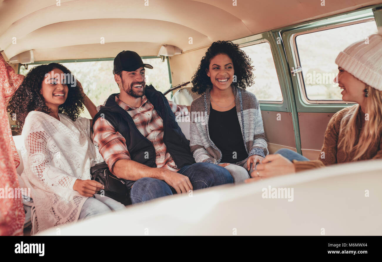 Multiethnic friends on roadtrip travelling together in a van. Group of ...