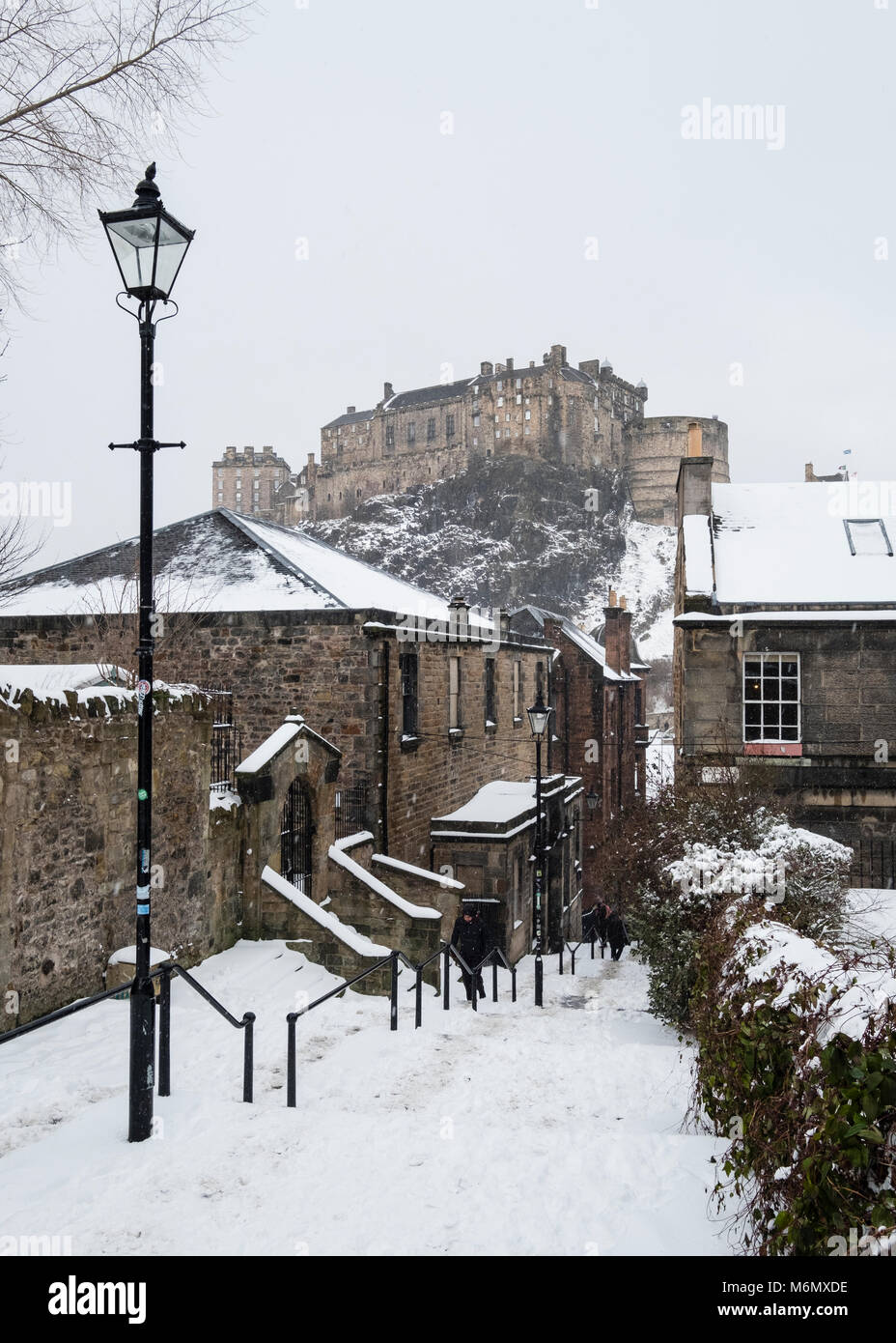 View of Edinburgh Castle after snow from the historic Vennel steps at ...