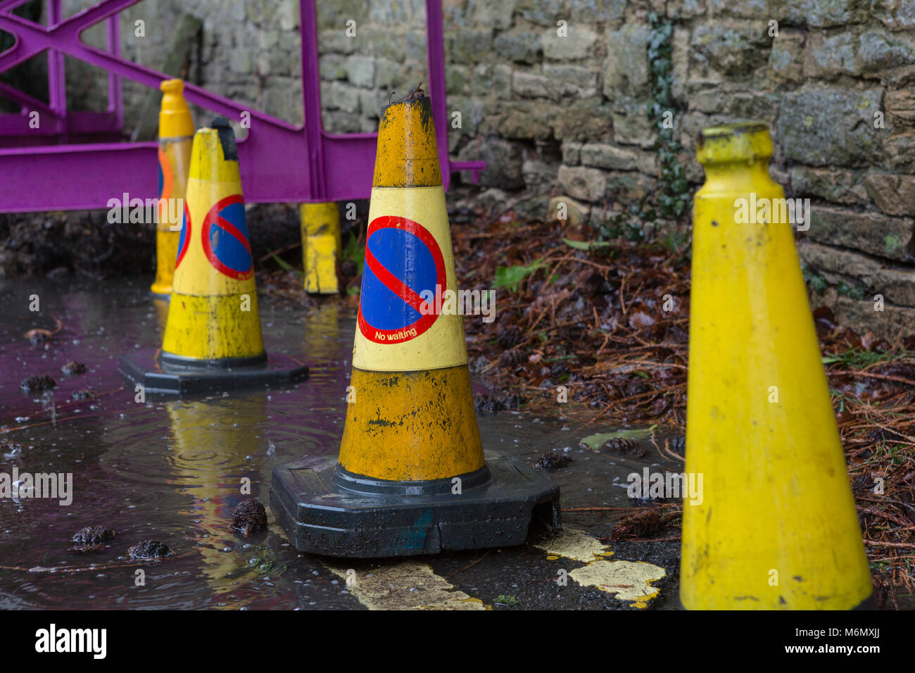 Traffic cones and barriers prtoecting an area of road where digging is ...