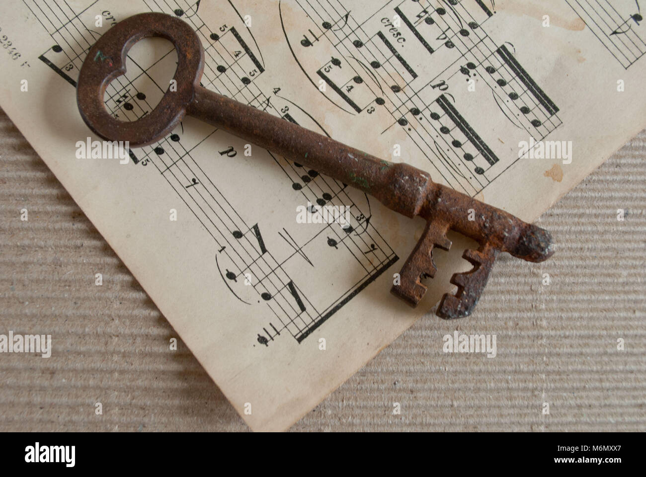 rust key on music sheet Stock Photo - Alamy