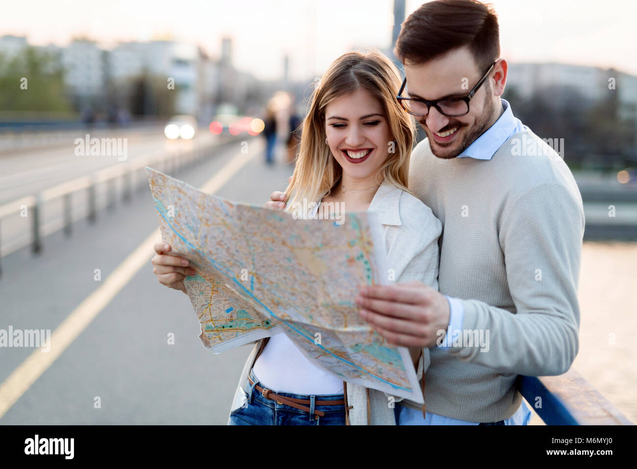 Tourist couple using map as guide Stock Photo - Alamy