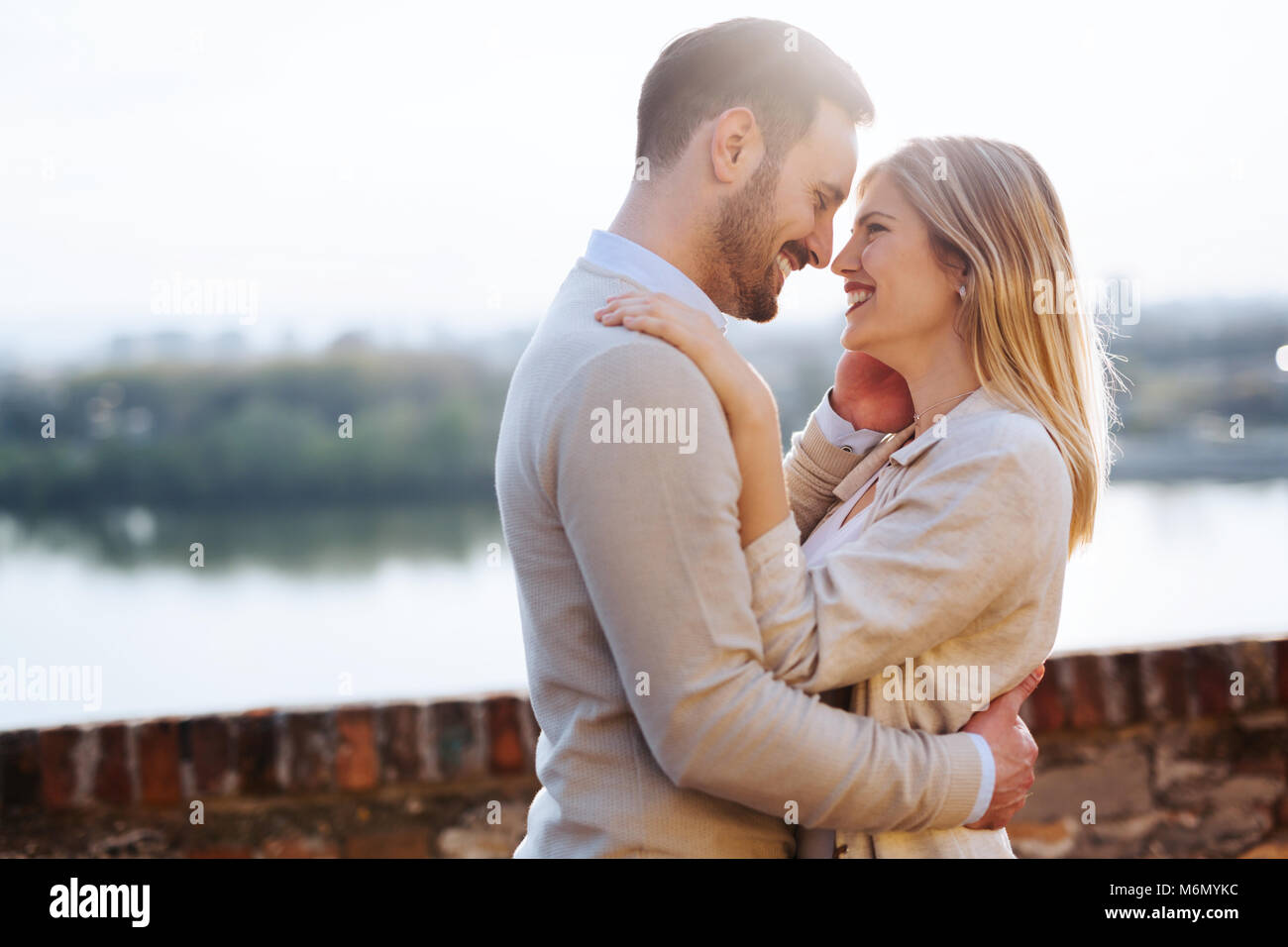 Happy couple in love hugging outdoor Stock Photo - Alamy