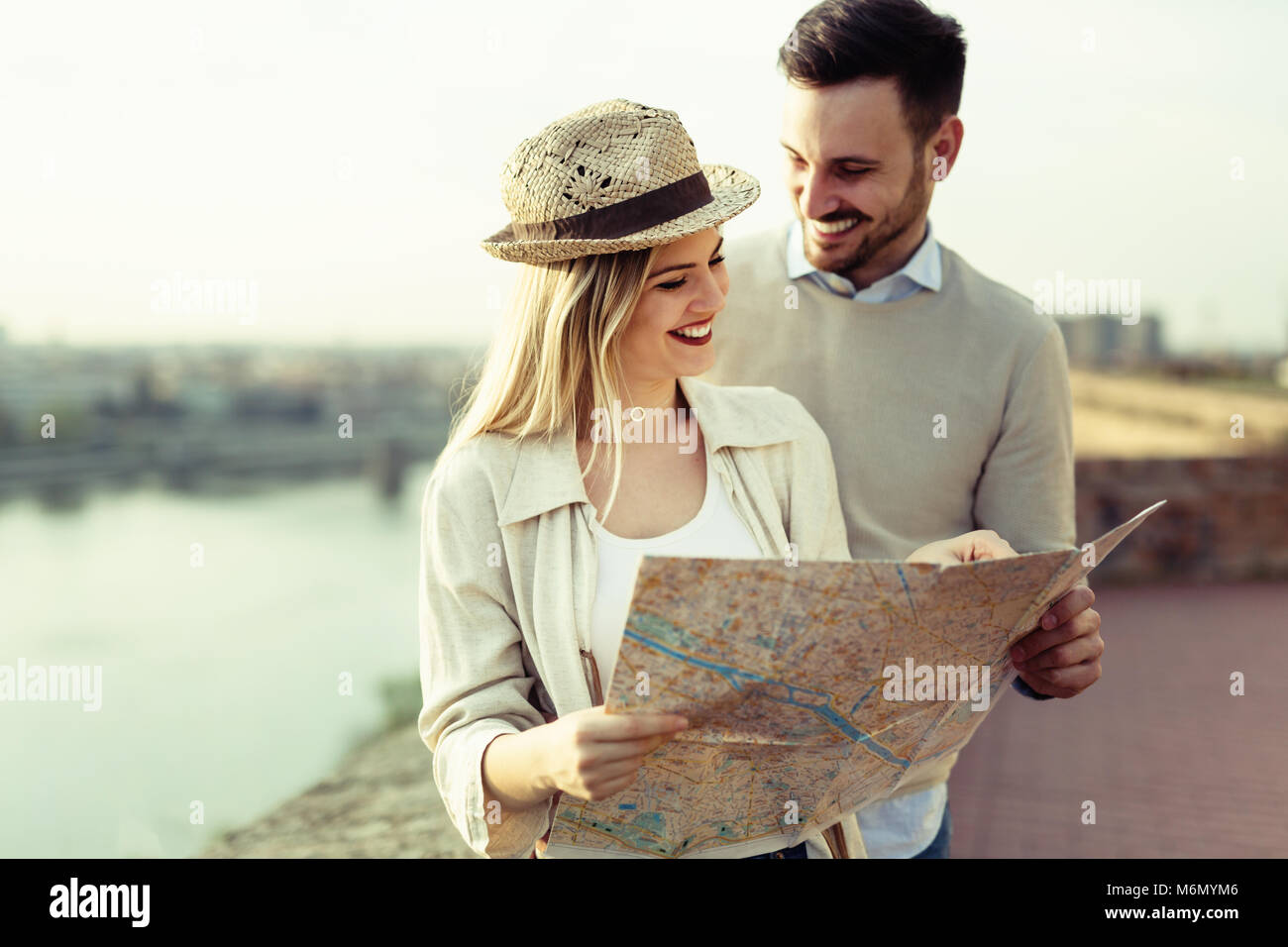 Tourist couple using map as guide Stock Photo - Alamy