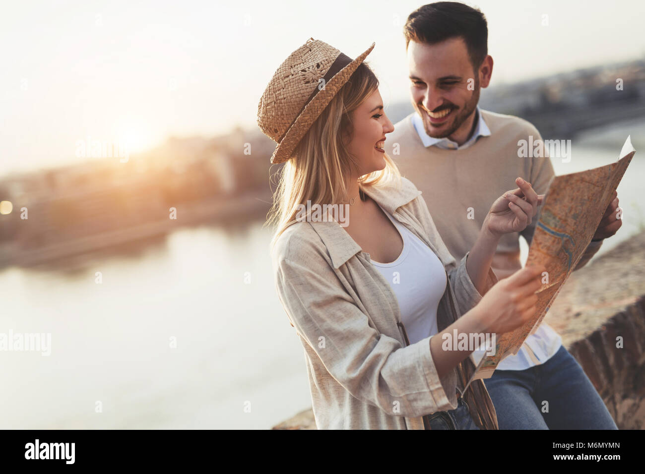 Tourist couple using map as guide Stock Photo - Alamy