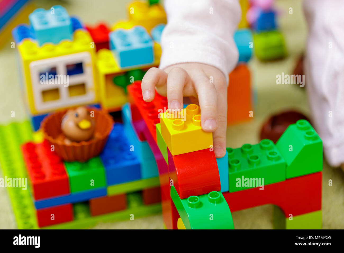 Children plastic color bricks with children hand. close up Stock Photo ...