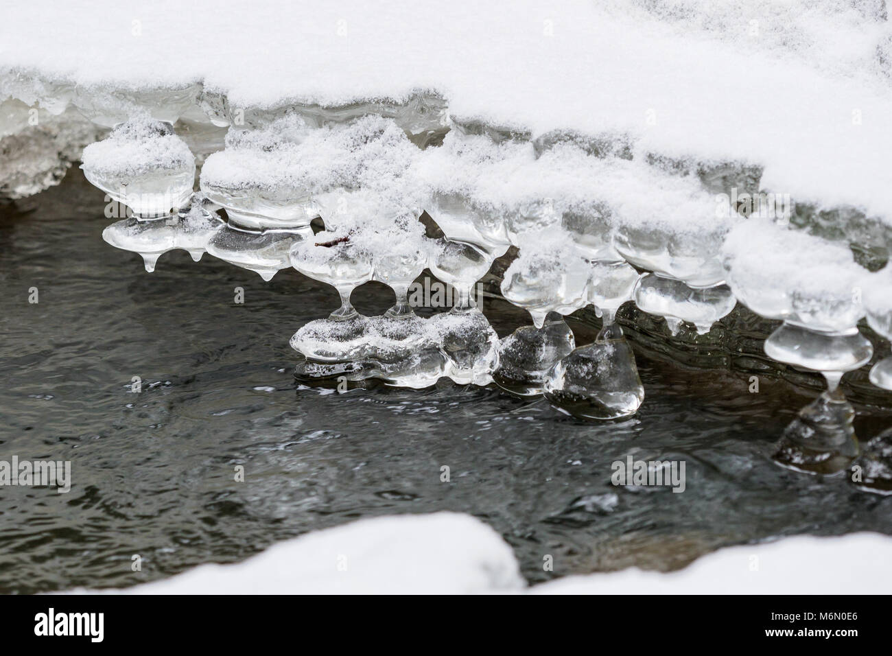 Little cascade with ice and icicles Stock Photo - Alamy