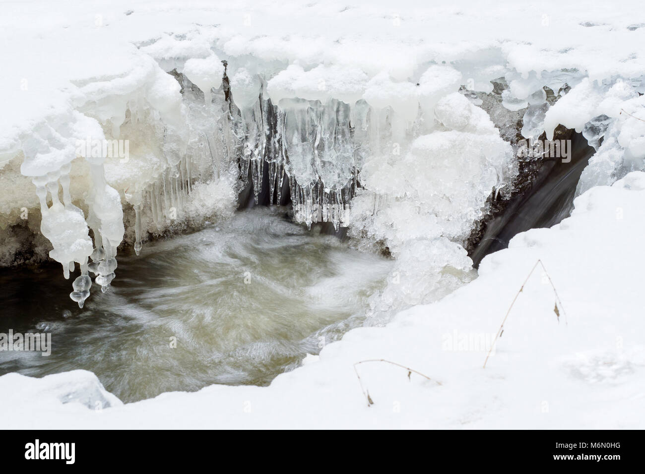 Little cascade with ice and icicles Stock Photo - Alamy