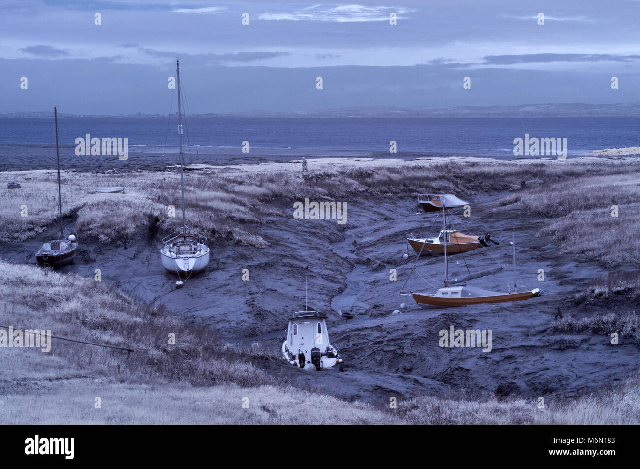 Infrared picture of boats high and dry on the edges of the creeks at ...