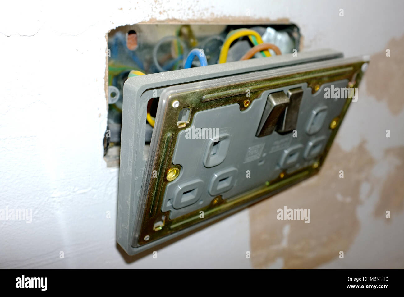 An exposed British electrical socket detached from the wall Stock Photo ...