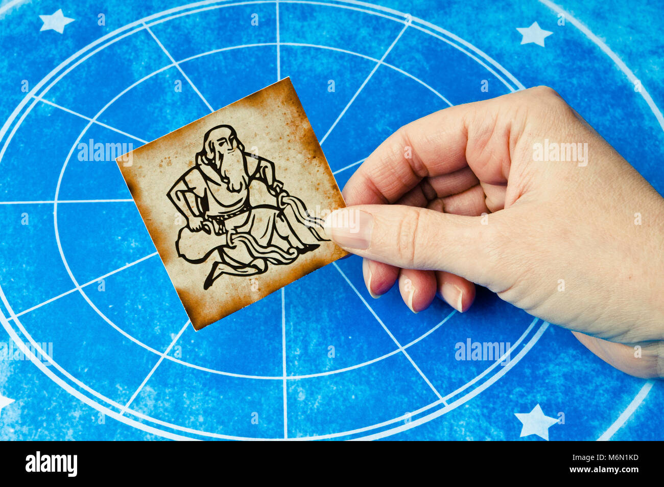 hand holding a card with sign of aquarius Stock Photo - Alamy