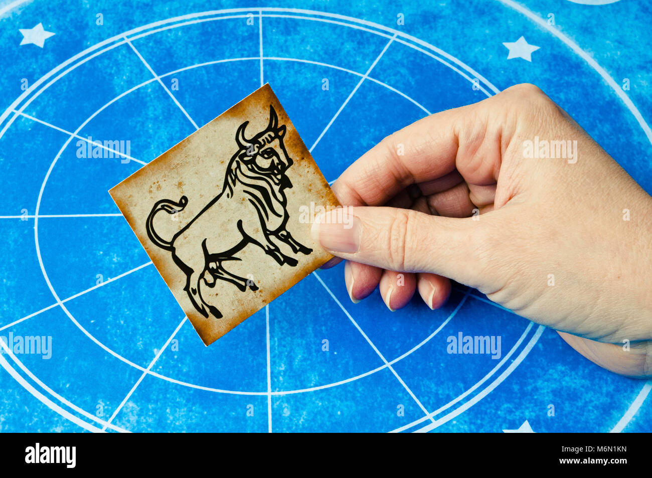 hand holding a card with sign of taurus Stock Photo - Alamy