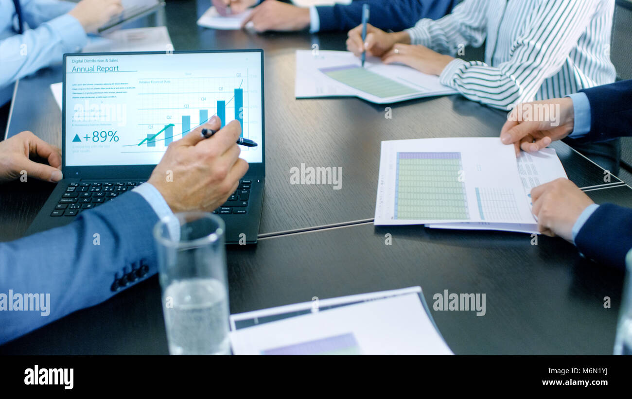 Shot of the Business Meeting Room Table with People Sharing Documents ...
