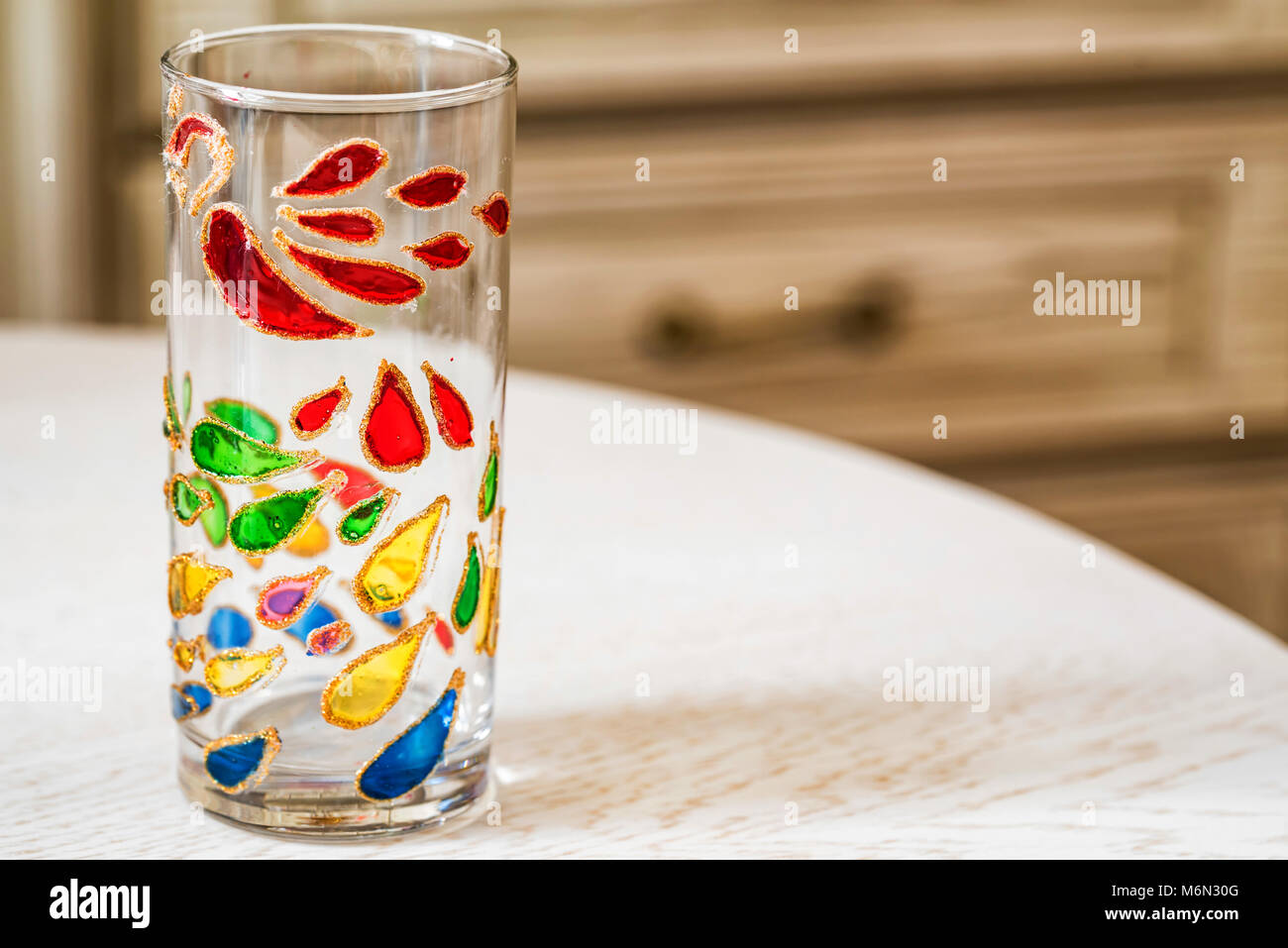Glass with colorful hand painting Stock Photo - Alamy