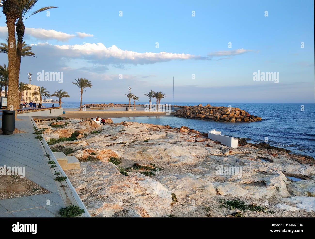 Torrevieja, Spain - February 17, 2018: People walking by the seafront ...