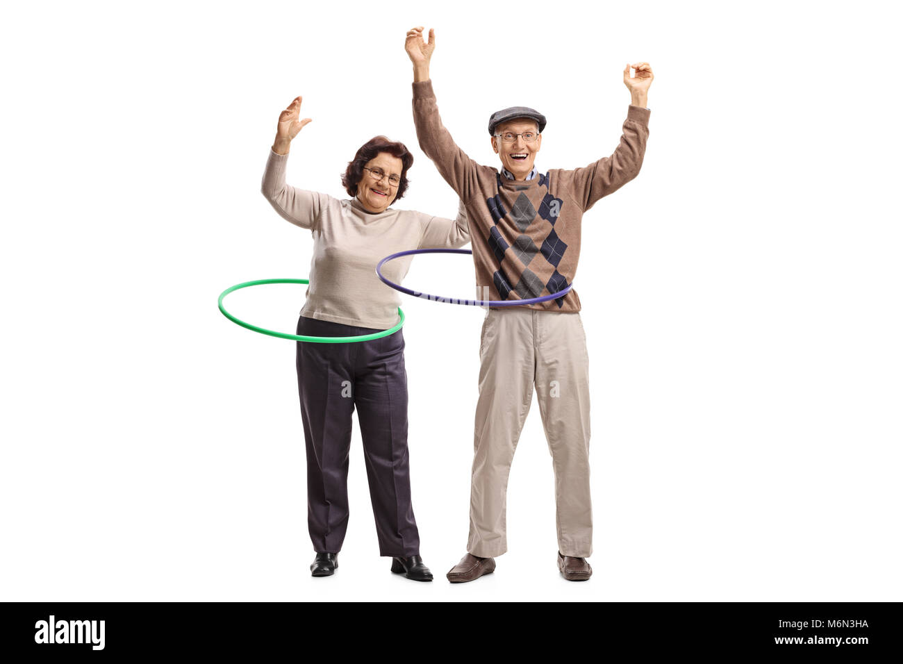 Full length portrait of two cheerful seniors with hula-hoops isolated ...