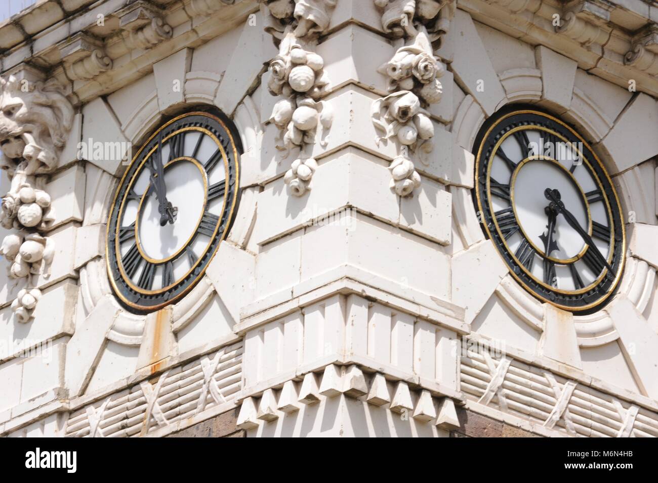 Clocks on building exterior Stock Photo - Alamy