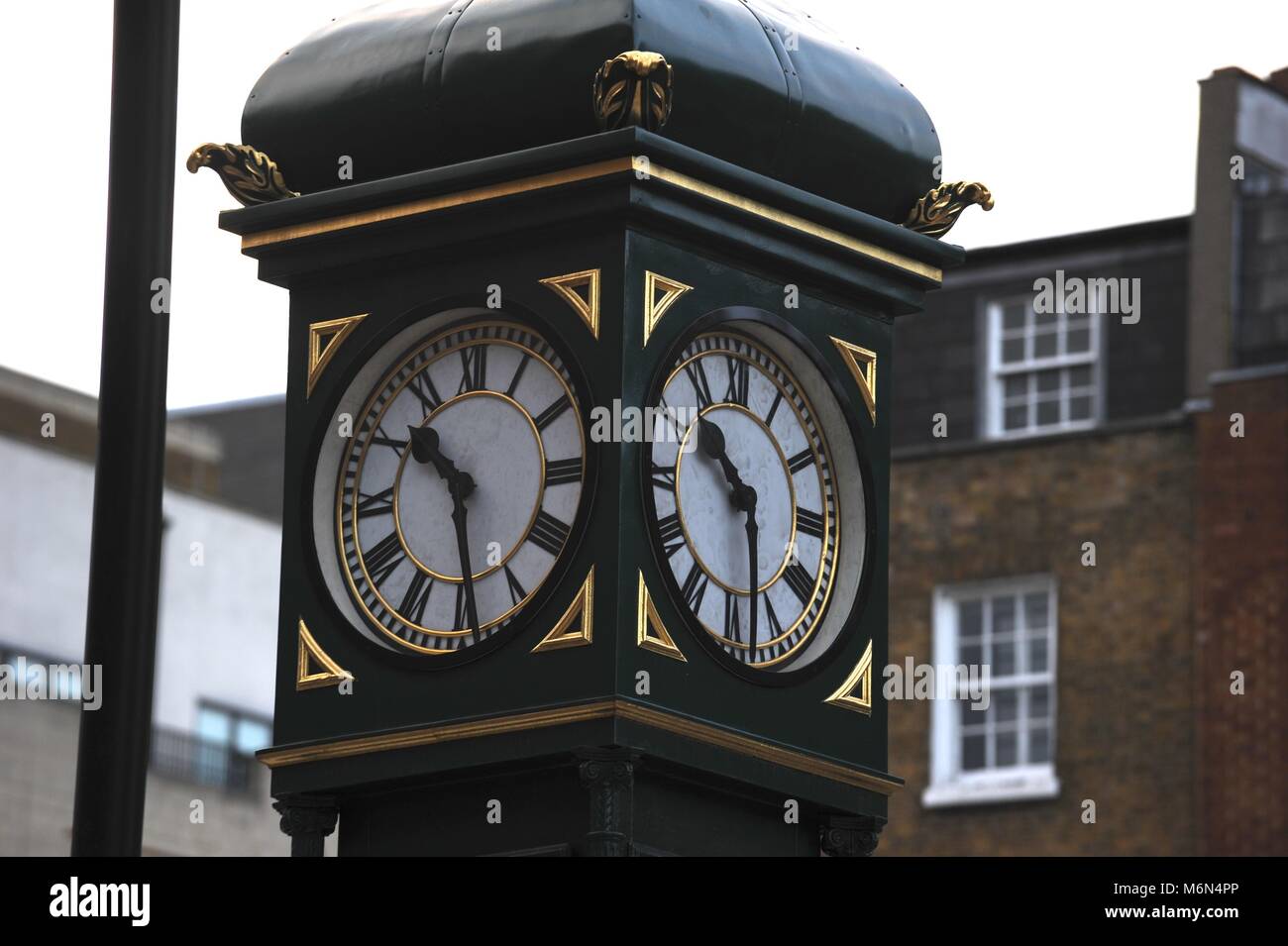 Clocks on building exterior Stock Photo - Alamy