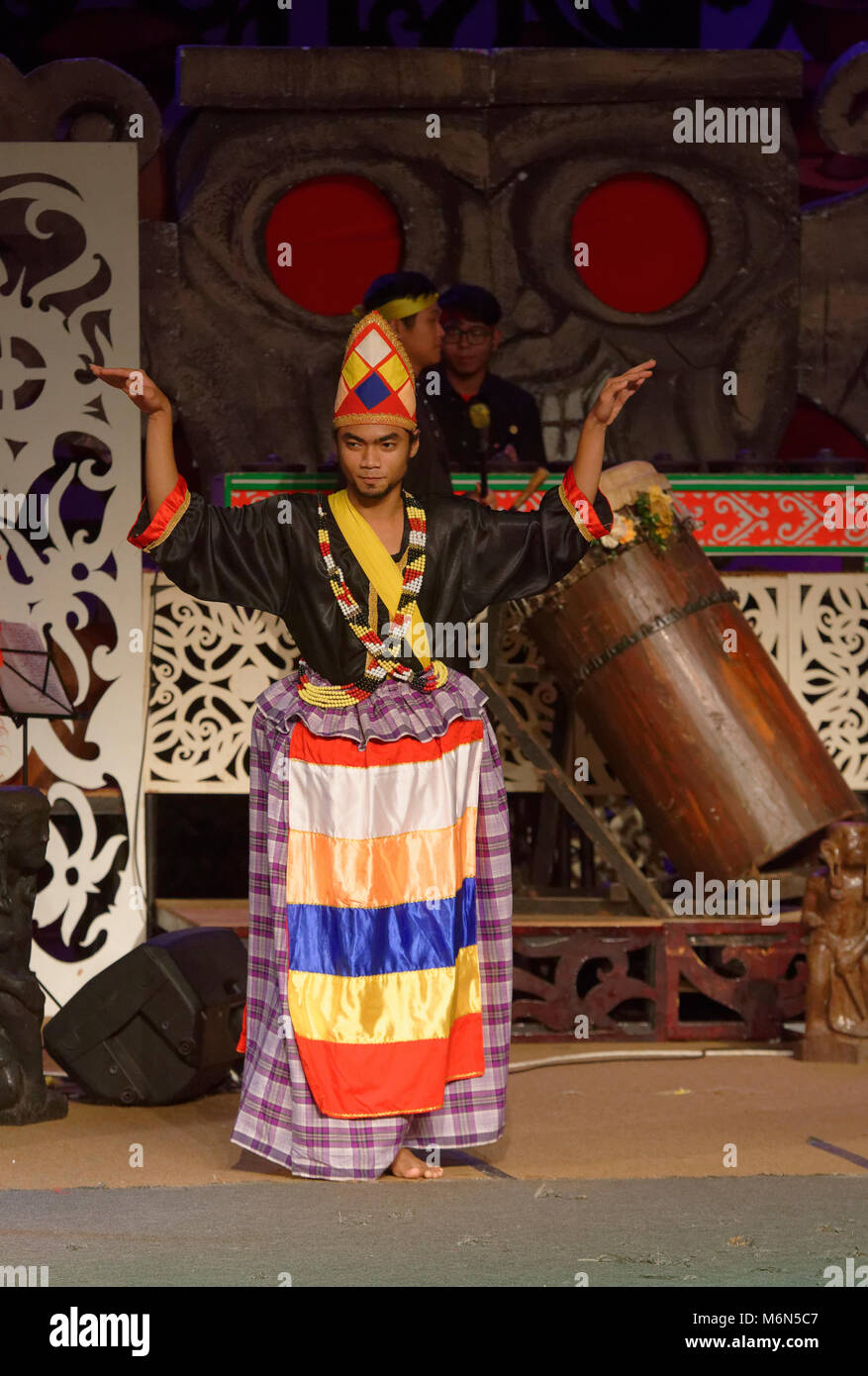 Dancers in traditional native costumes at the Sarawak Cultural Village ...