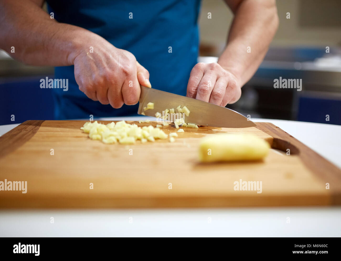 Single man cooking at home, chopping ginger for a recipe Stock Photo ...