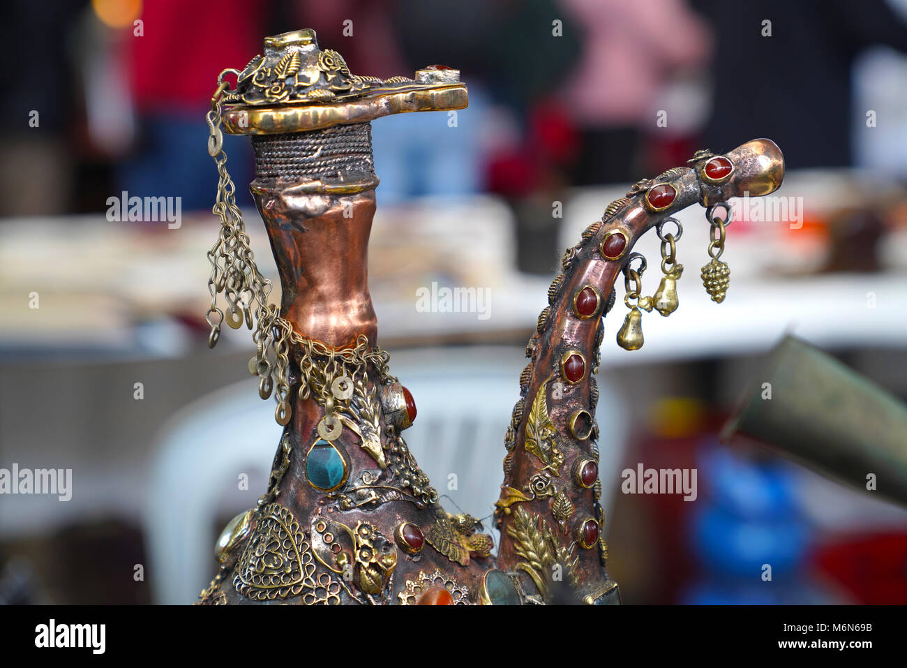Oriental pitcher decorated with beads and chains Stock Photo - Alamy