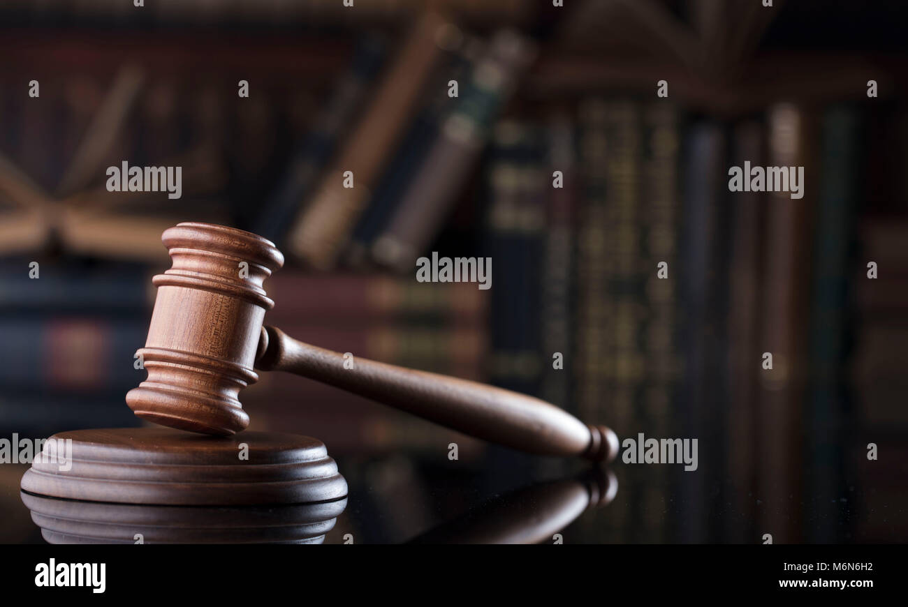 Law theme. Court library. Judge’s gavel on book background. Place for ...